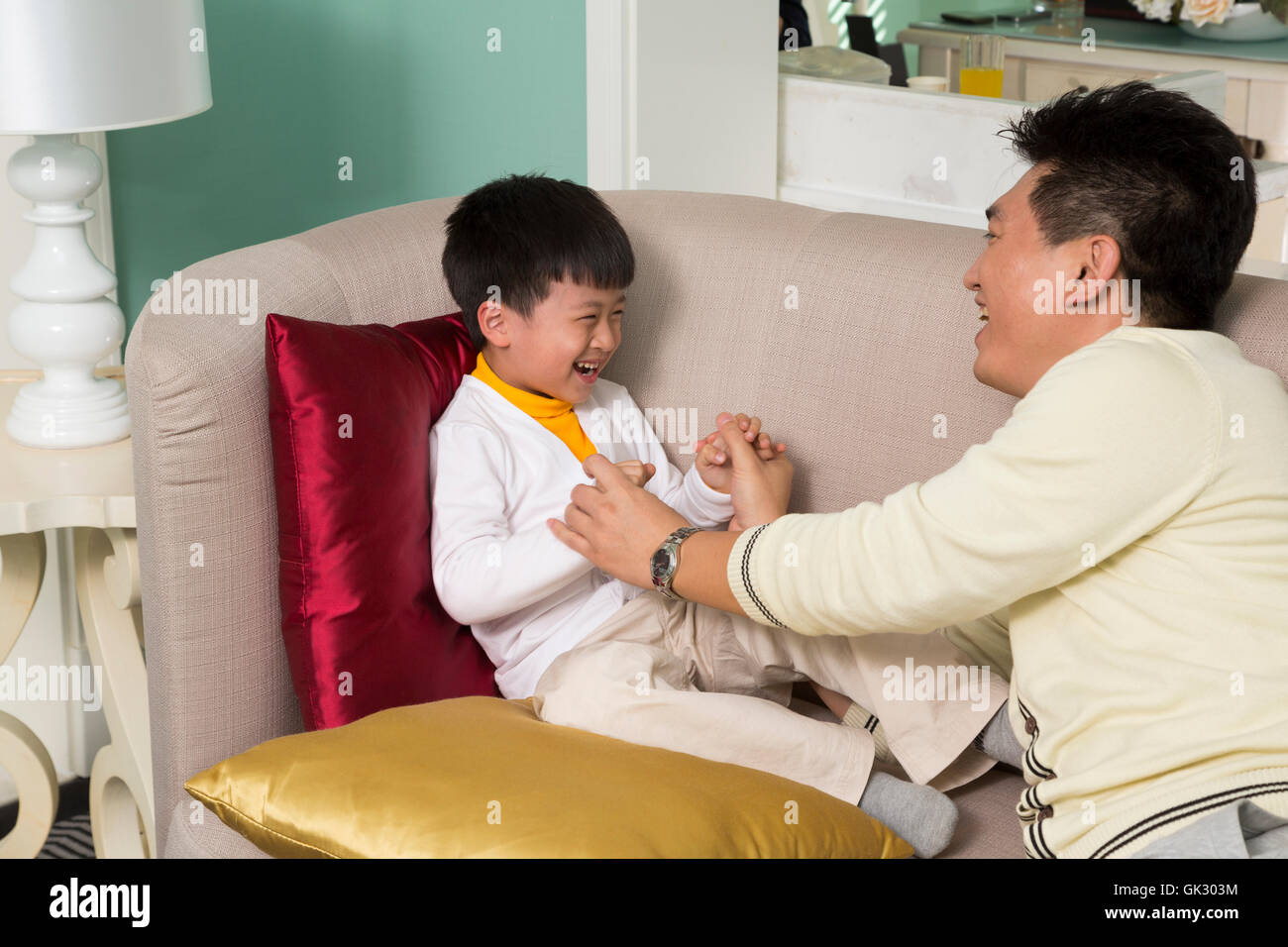 Father and son in the living room Stock Photo - Alamy