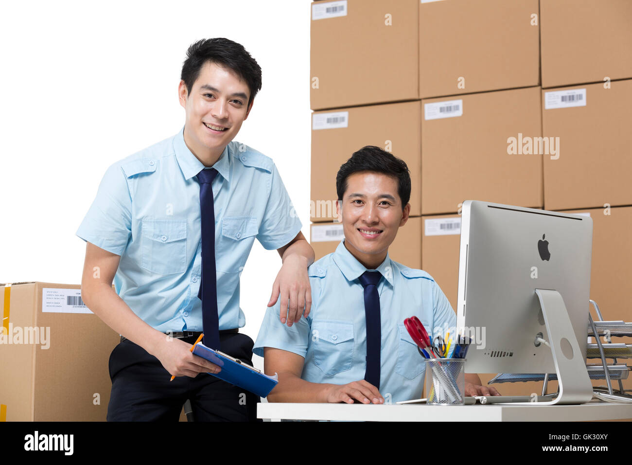 Logistics warehouse staff in the use of office computers Stock Photo ...