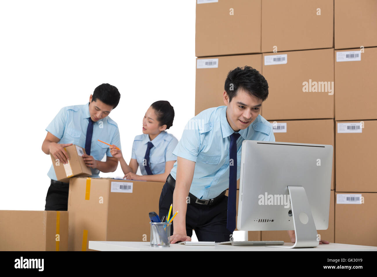 Logistics warehouse staff in the use of office computers Stock Photo ...