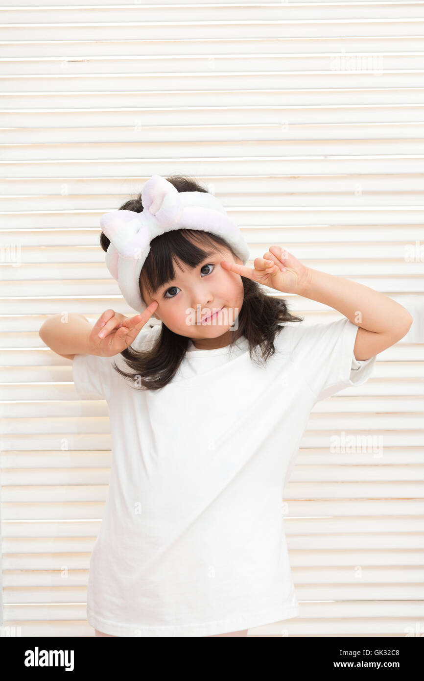 Cute little girl making faces Stock Photo - Alamy