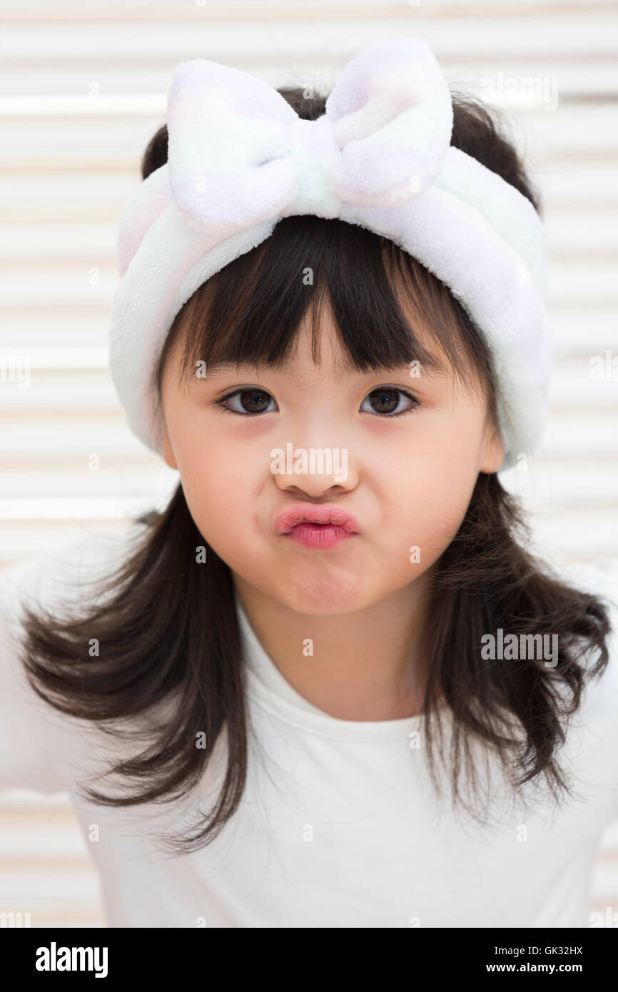 Cute little girl making faces Stock Photo - Alamy
