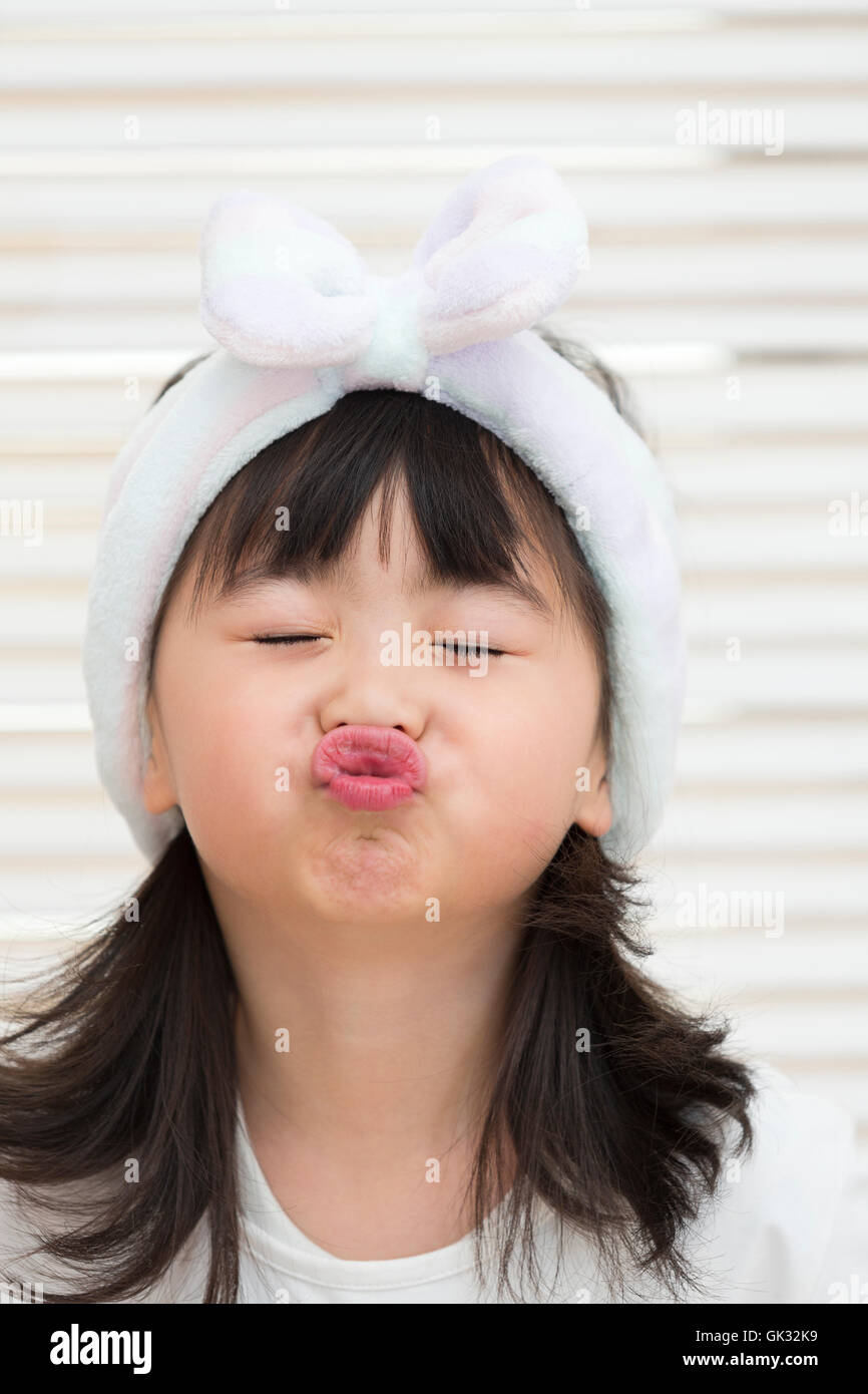 Cute little girl making faces Stock Photo - Alamy