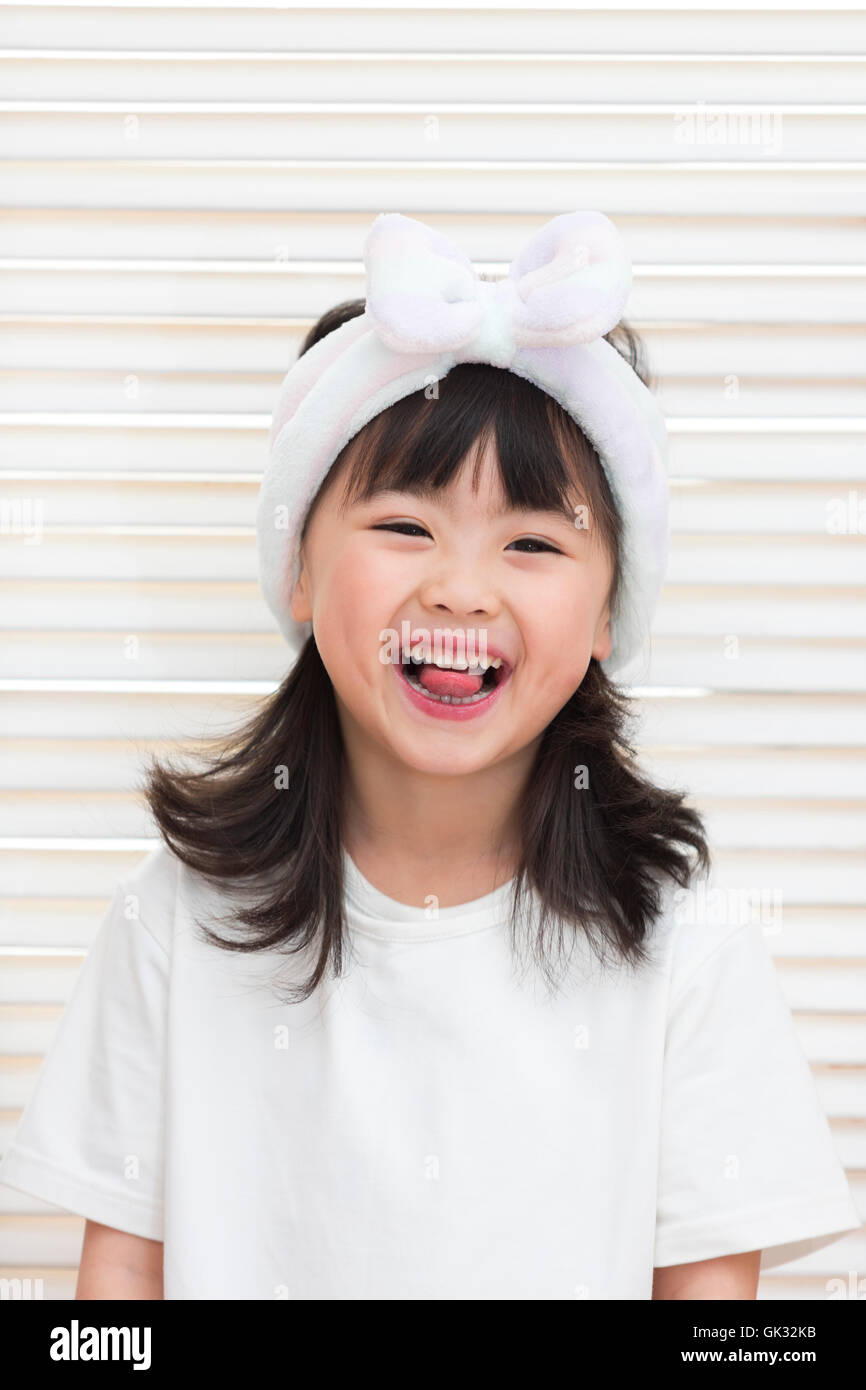 Cute little girl making faces Stock Photo - Alamy