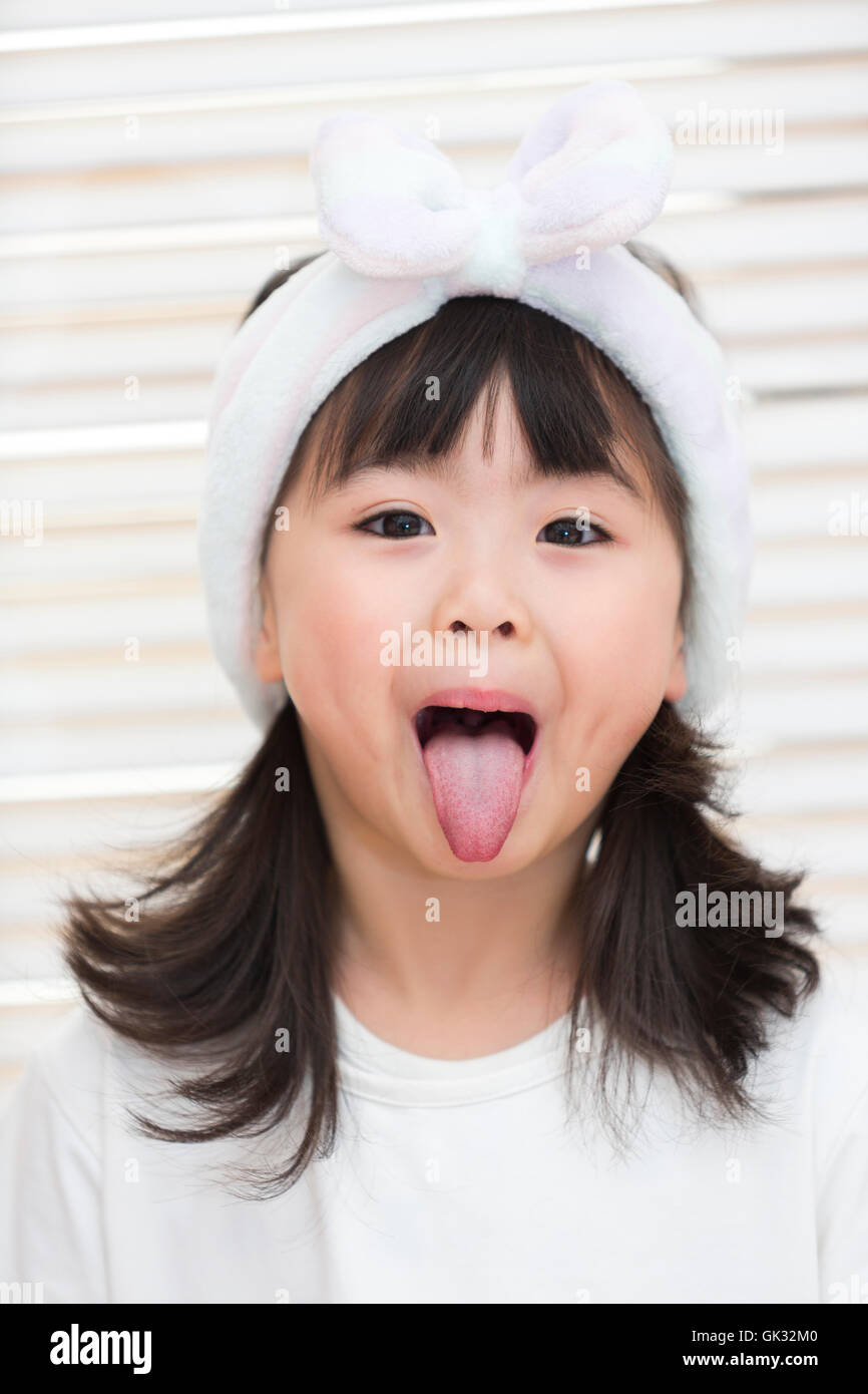 Cute little girl making faces Stock Photo - Alamy