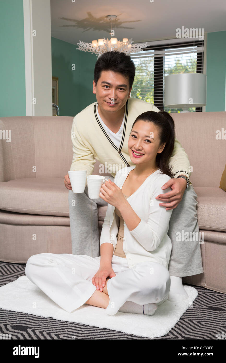 Couple in the living room Stock Photo - Alamy