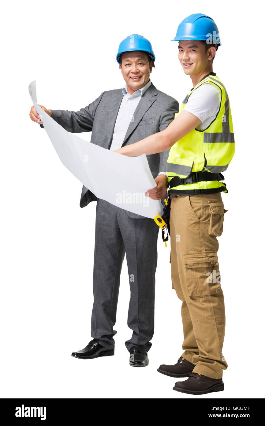 Middle-aged male construction engineers and construction workers look ...