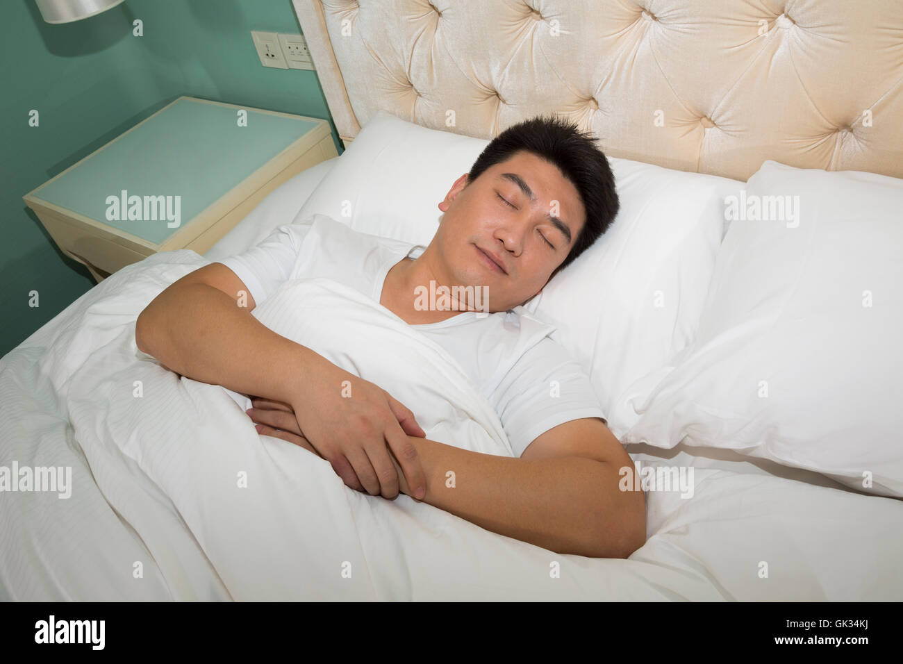 Middle-aged man in the bedroom to rest Stock Photo - Alamy