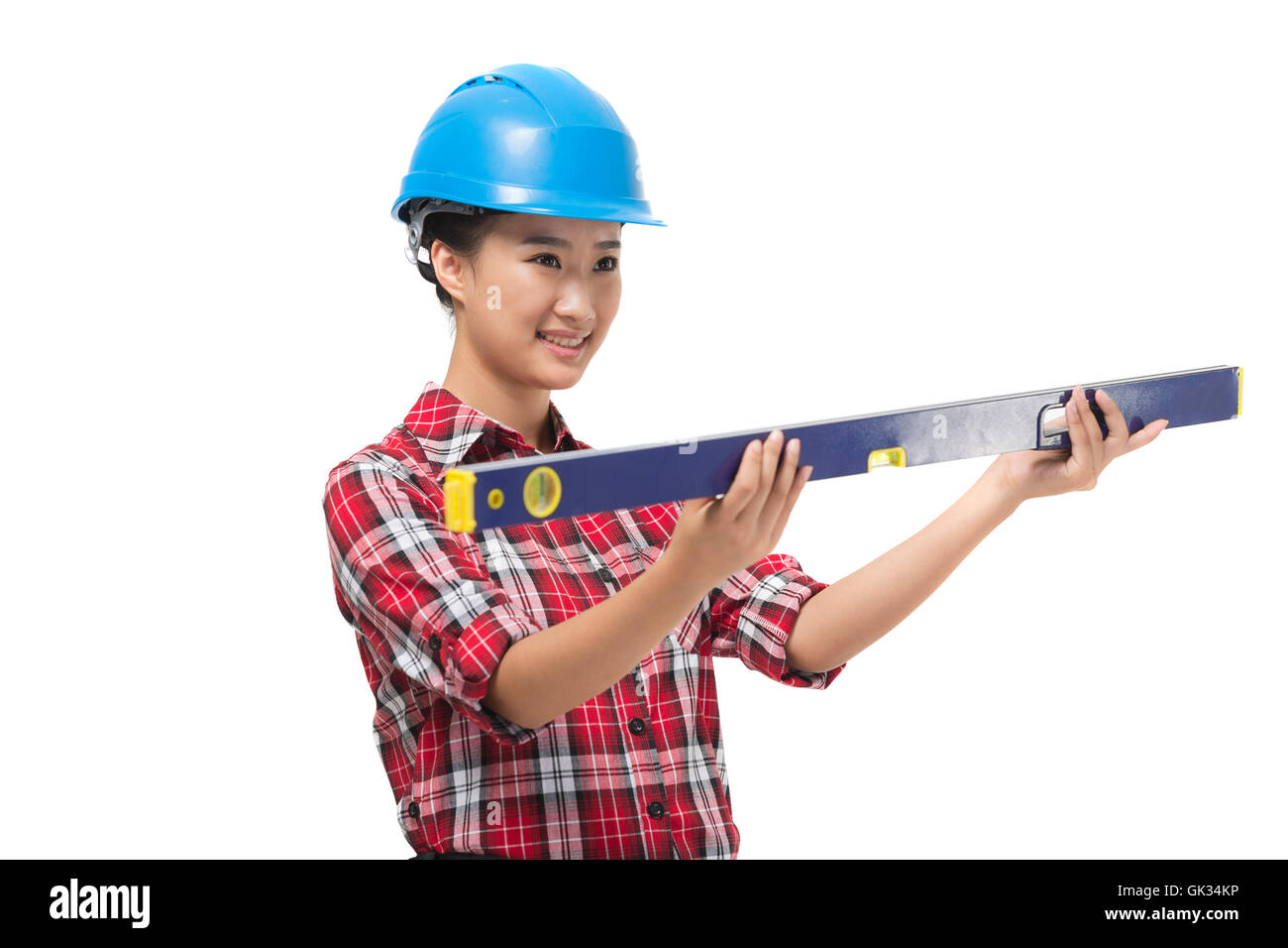 Young female construction worker holding level instrument Stock Photo ...