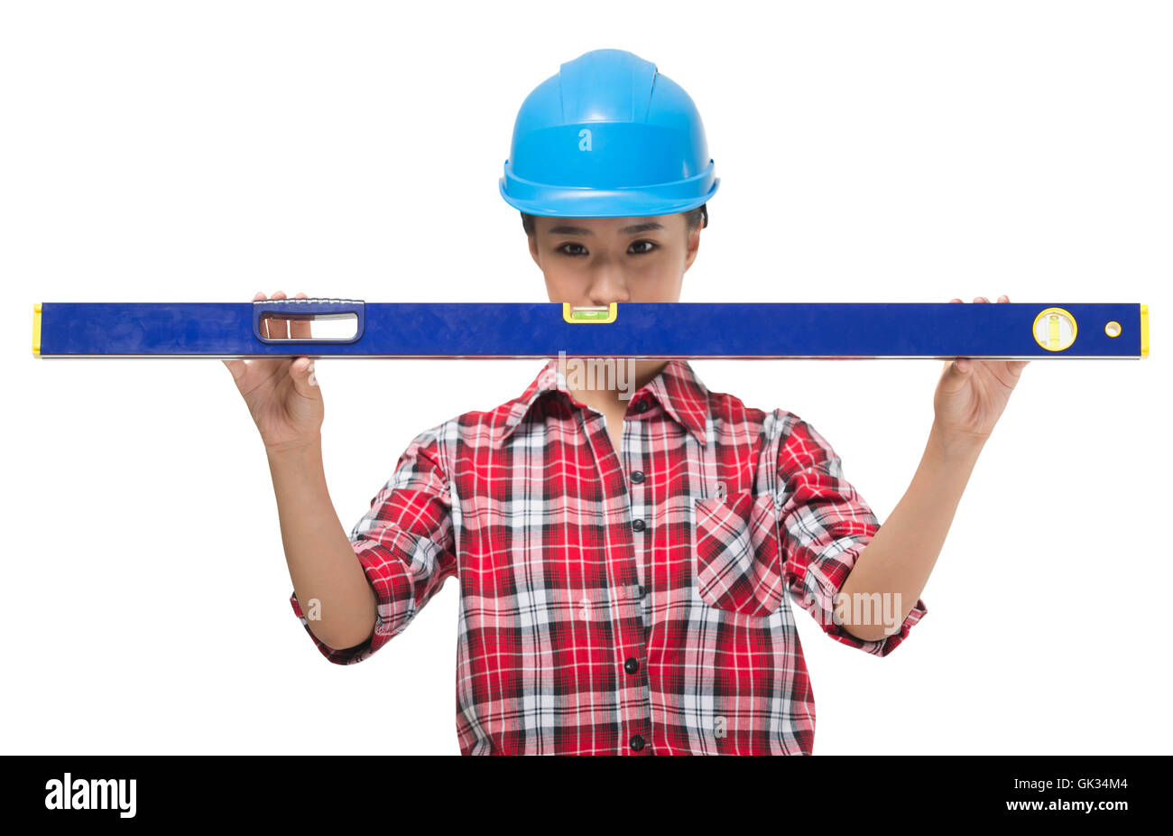 Young female construction worker holding level instrument Stock Photo ...