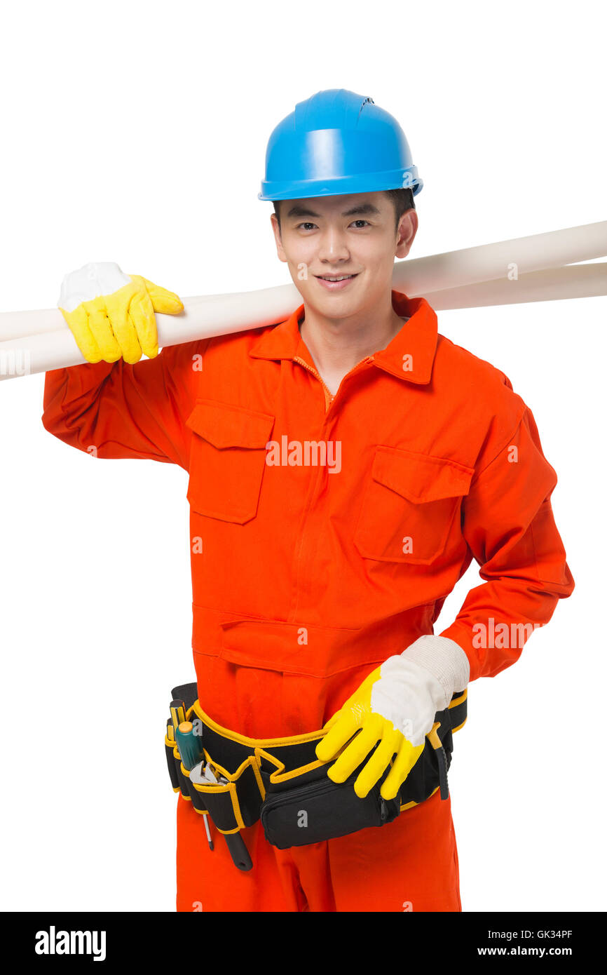 Young construction worker carrying building materials Stock Photo - Alamy