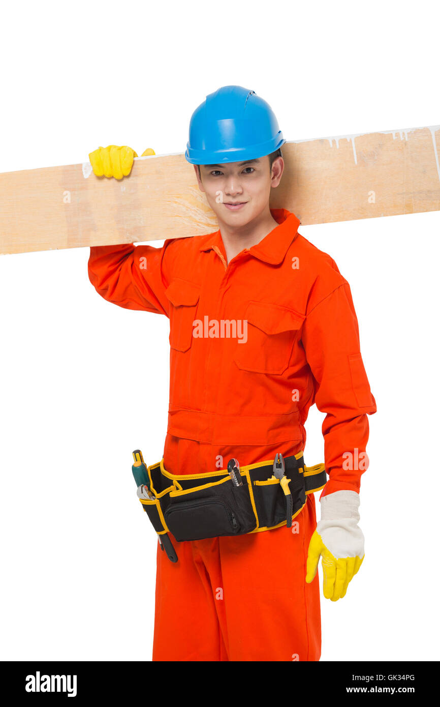Young construction worker carrying building materials Stock Photo - Alamy