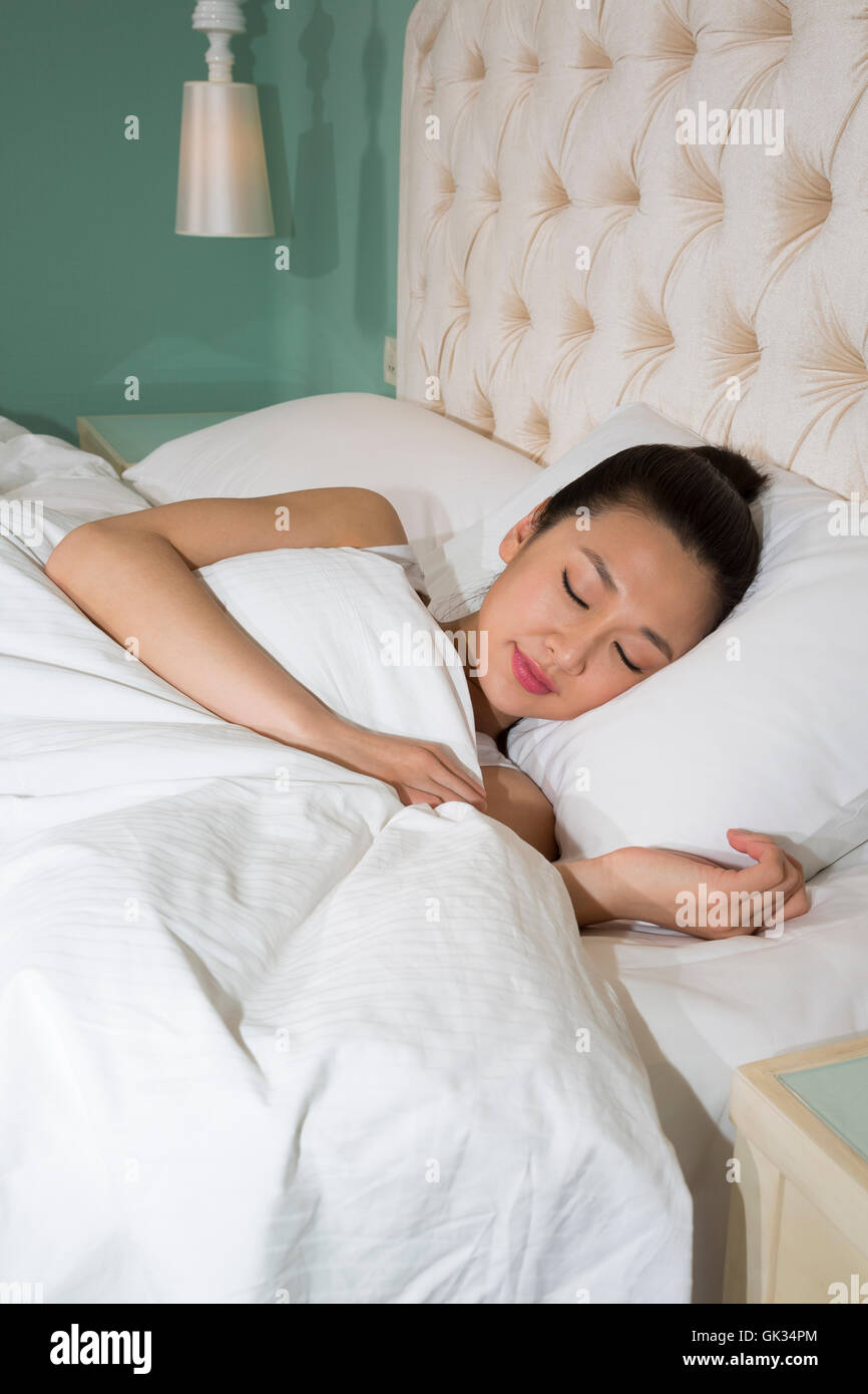 Young woman resting in the bedroom Stock Photo - Alamy