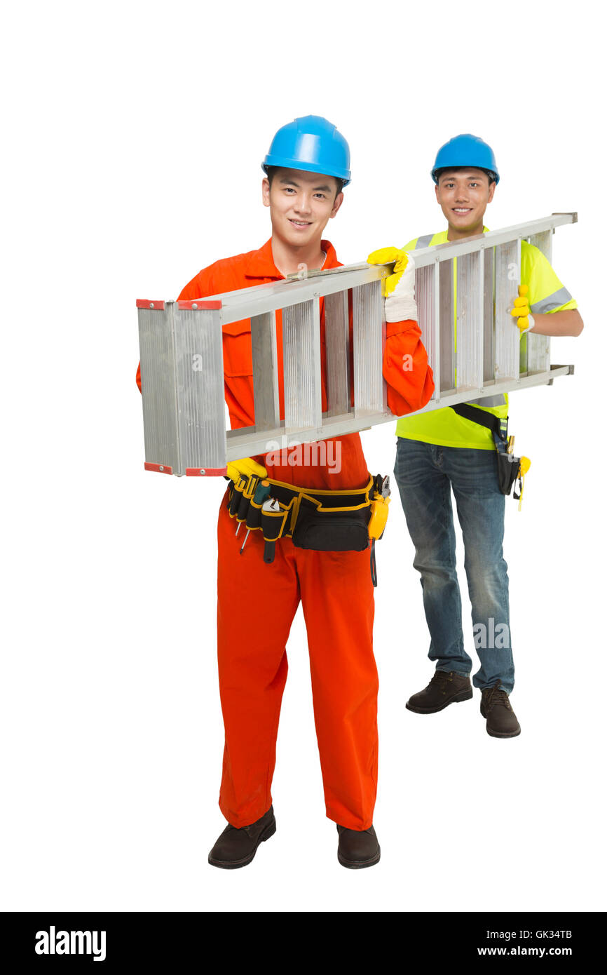 Young construction worker carrying a ladder Stock Photo - Alamy