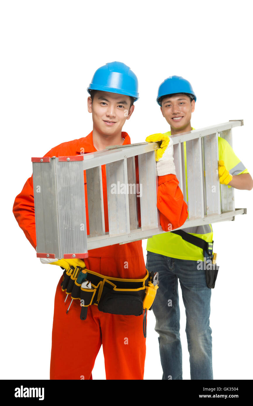 Young construction worker carrying a ladder Stock Photo - Alamy