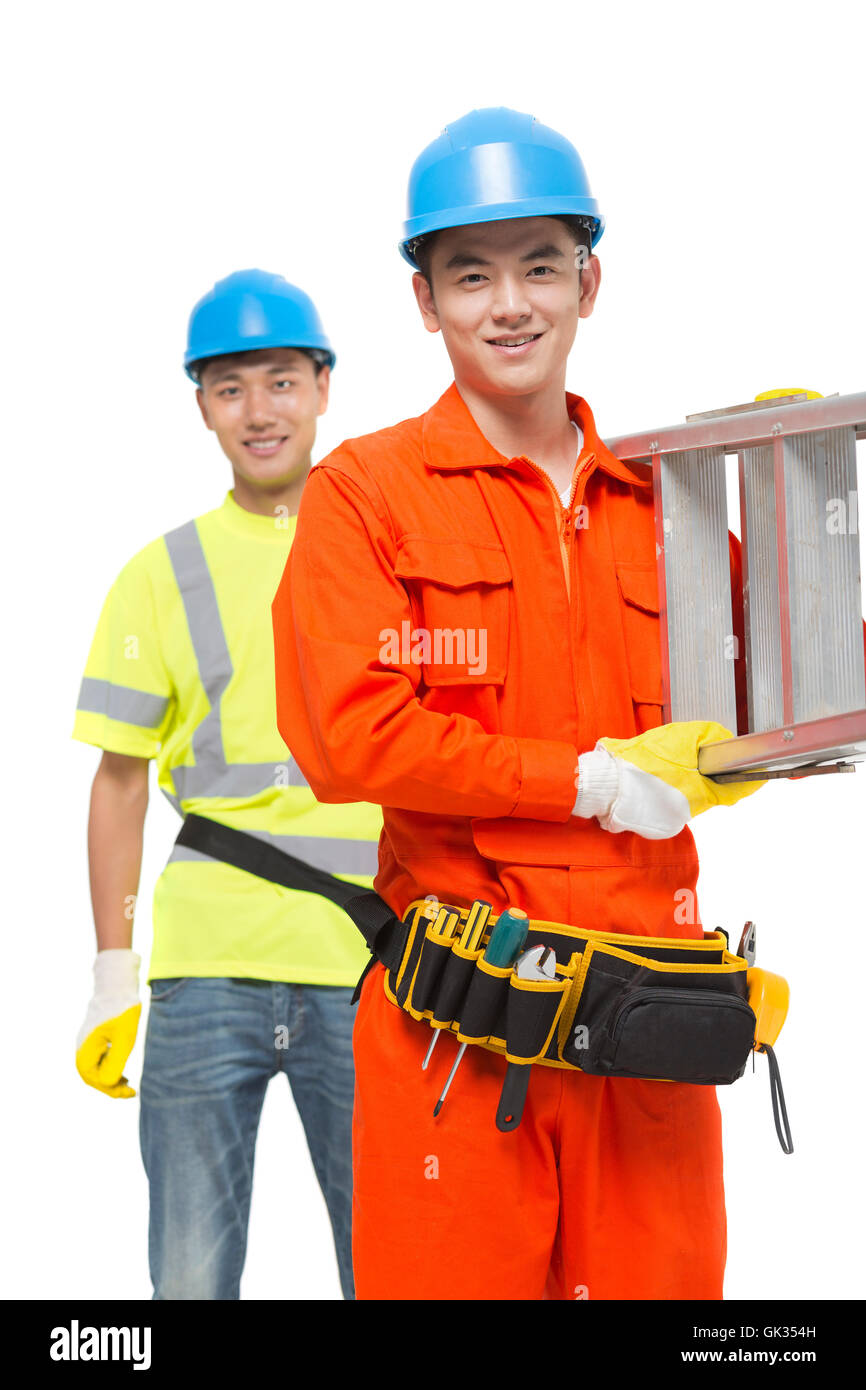 Young construction worker carrying a ladder Stock Photo - Alamy