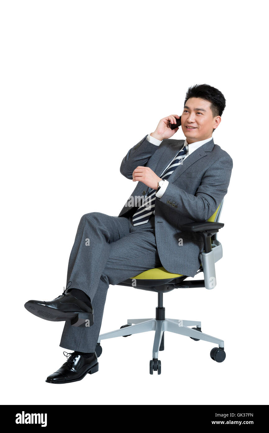 Studio shot business man sitting in office chair Call Stock Photo - Alamy