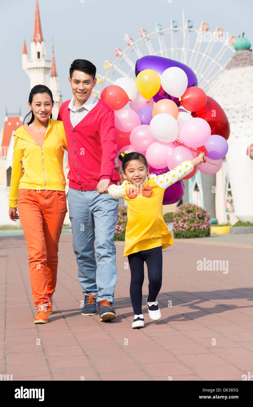 Happy family of three to go to the amusement park Stock Photo - Alamy