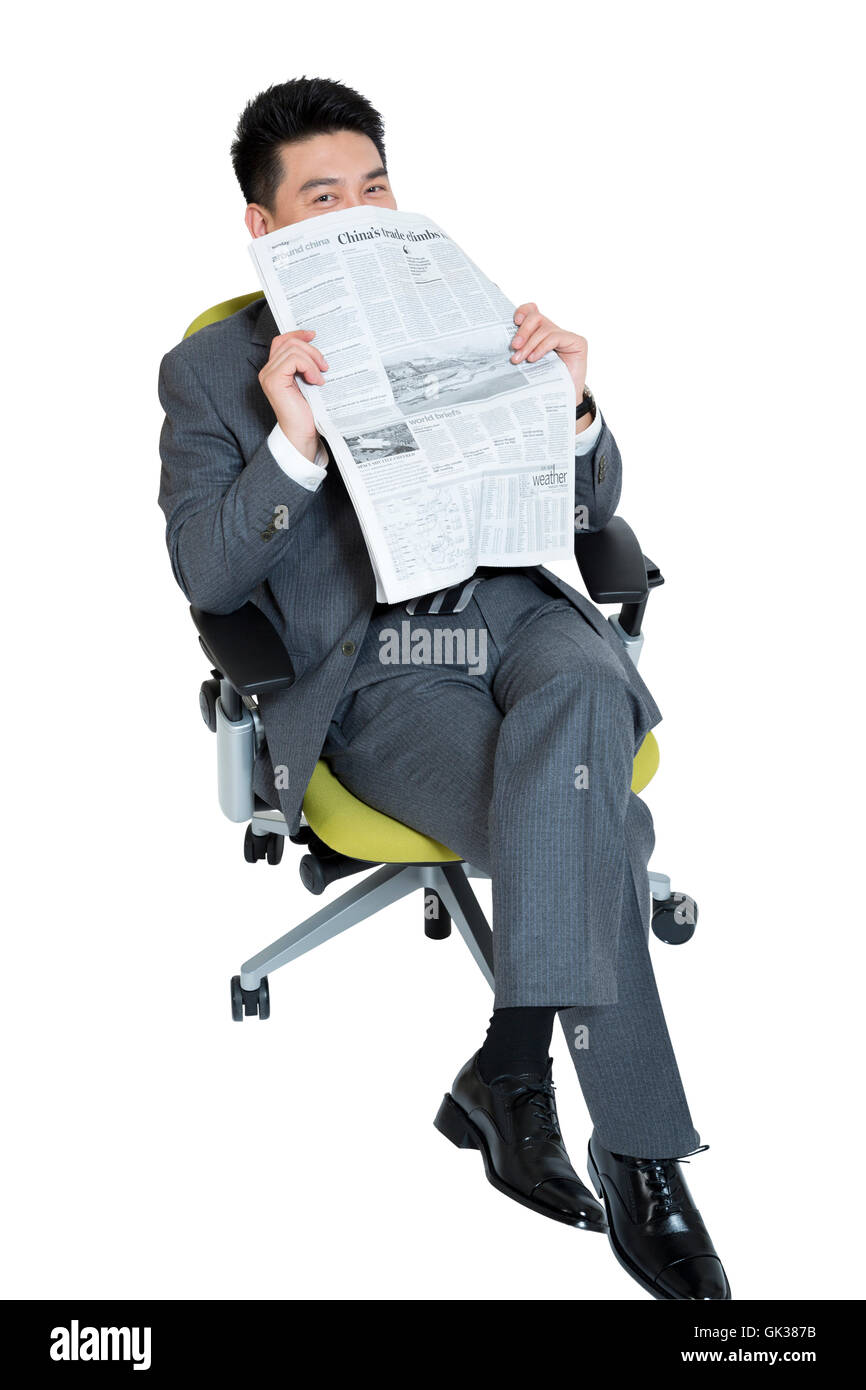 Man sitting on a chair reading a newspaper Cut Out Stock Images ...