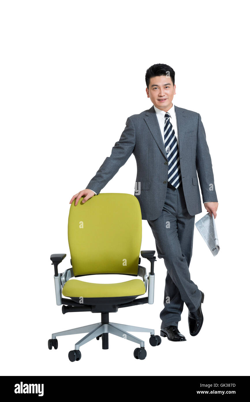 Studio shot business men standing next to the chair Stock Photo - Alamy