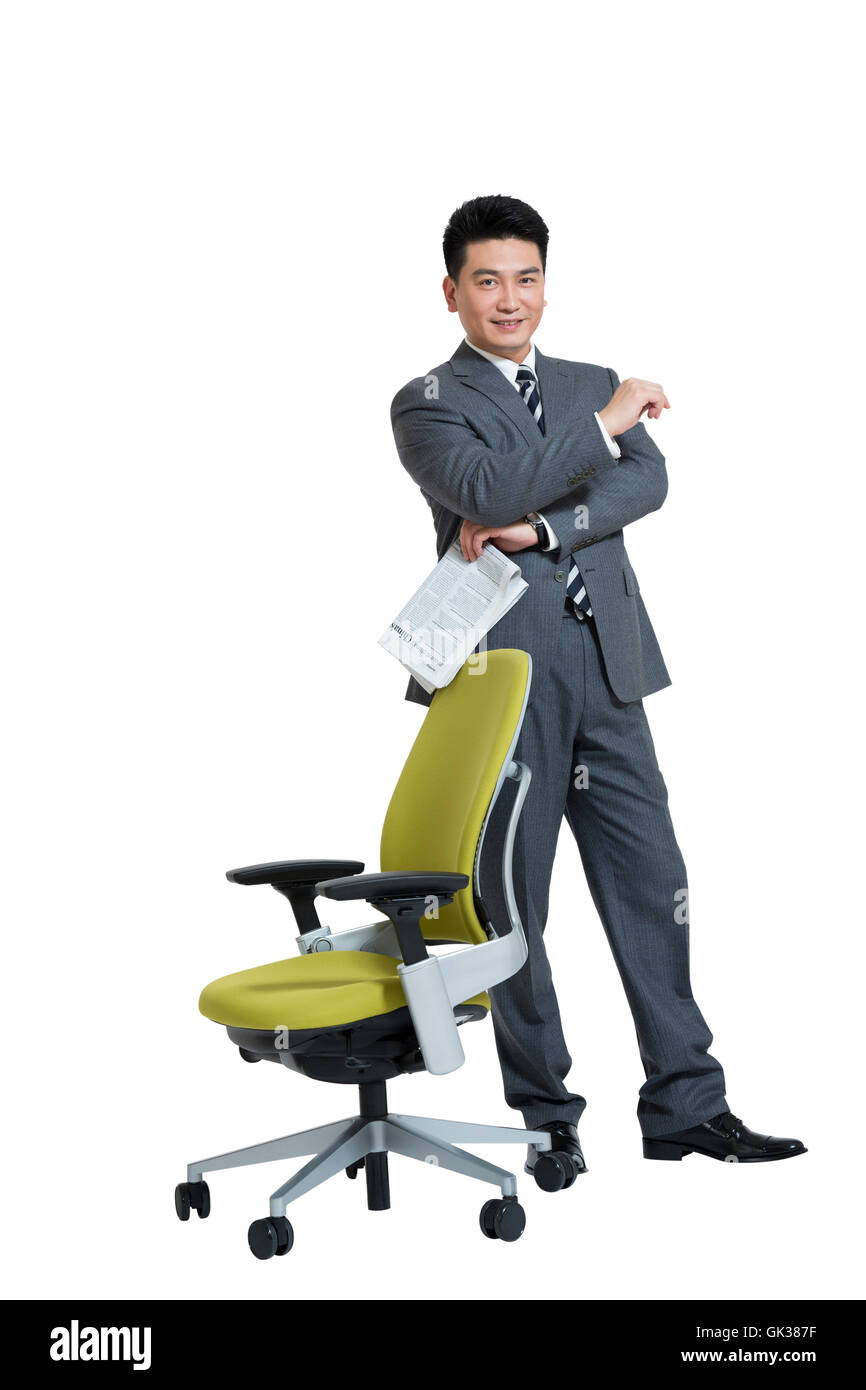 Studio shot business men standing next to the chair Stock Photo - Alamy