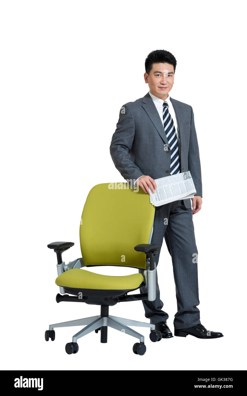 Studio shot business men standing next to the chair Stock Photo - Alamy