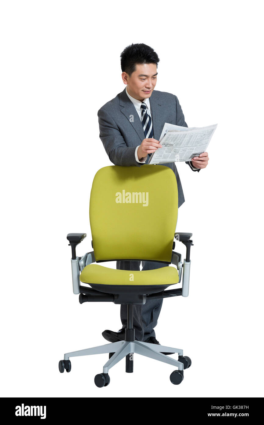 Studio shot business men standing next to the chair Stock Photo - Alamy