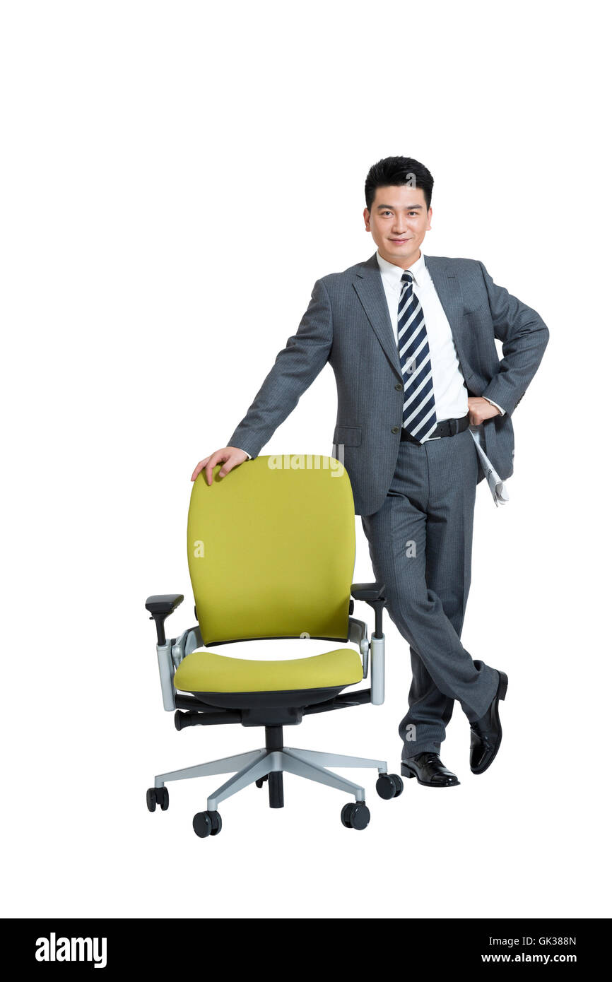Studio shot business men standing next to the chair Stock Photo - Alamy