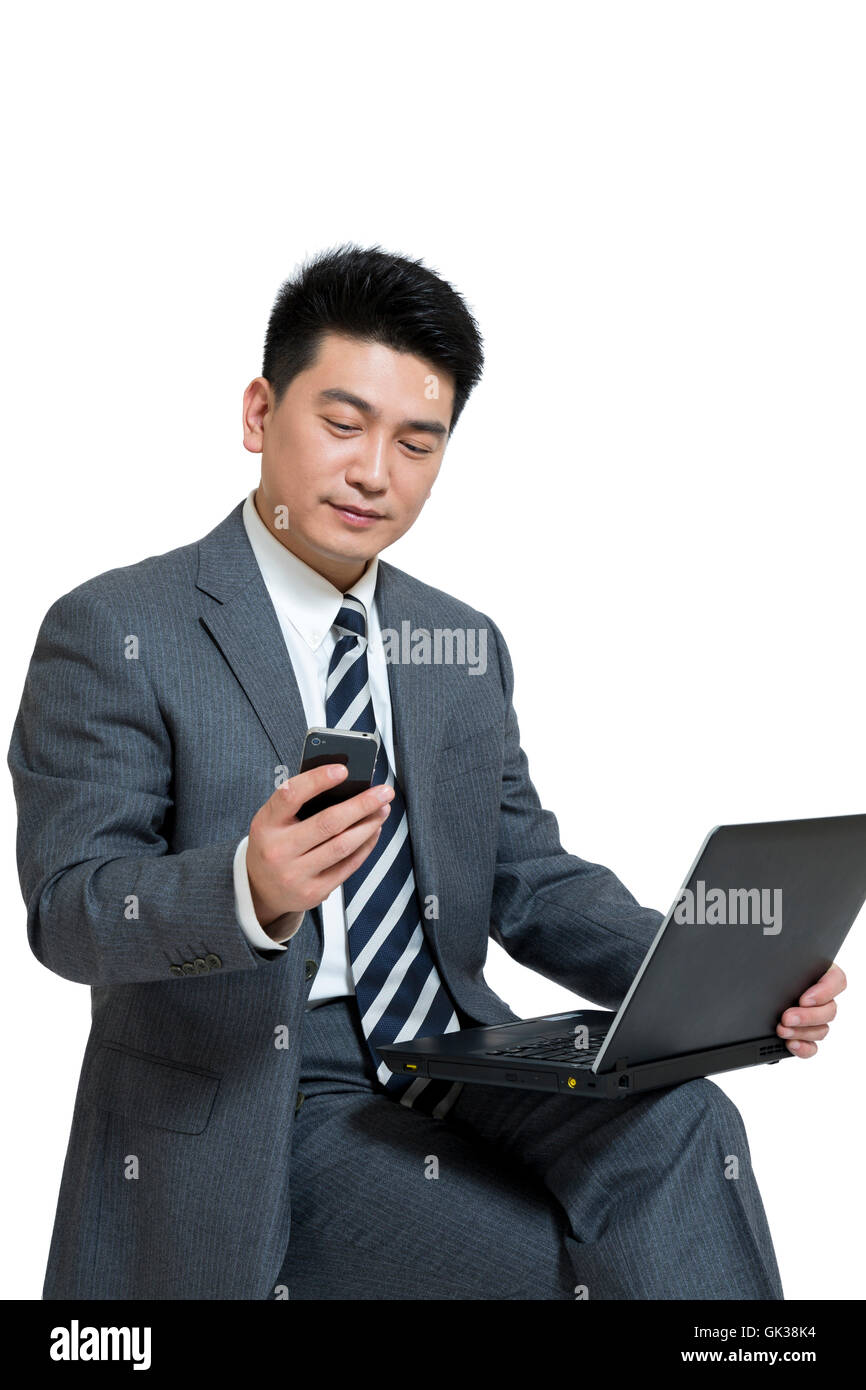 Studio shot business men using laptop Stock Photo - Alamy