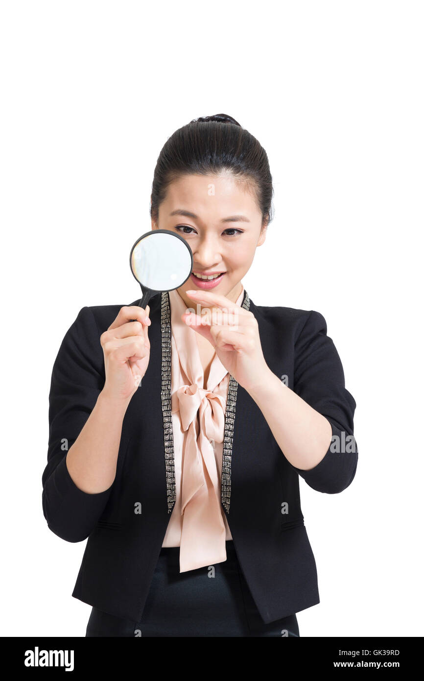 Studio shot Business women and a magnifying glass Stock Photo - Alamy