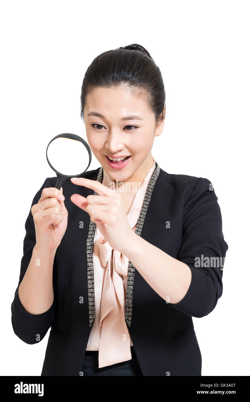 Studio shot Business women and a magnifying glass Stock Photo - Alamy