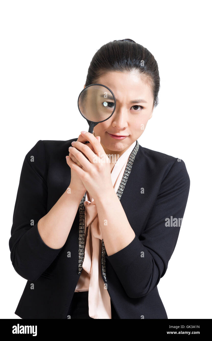 Studio shot Business women and a magnifying glass Stock Photo - Alamy