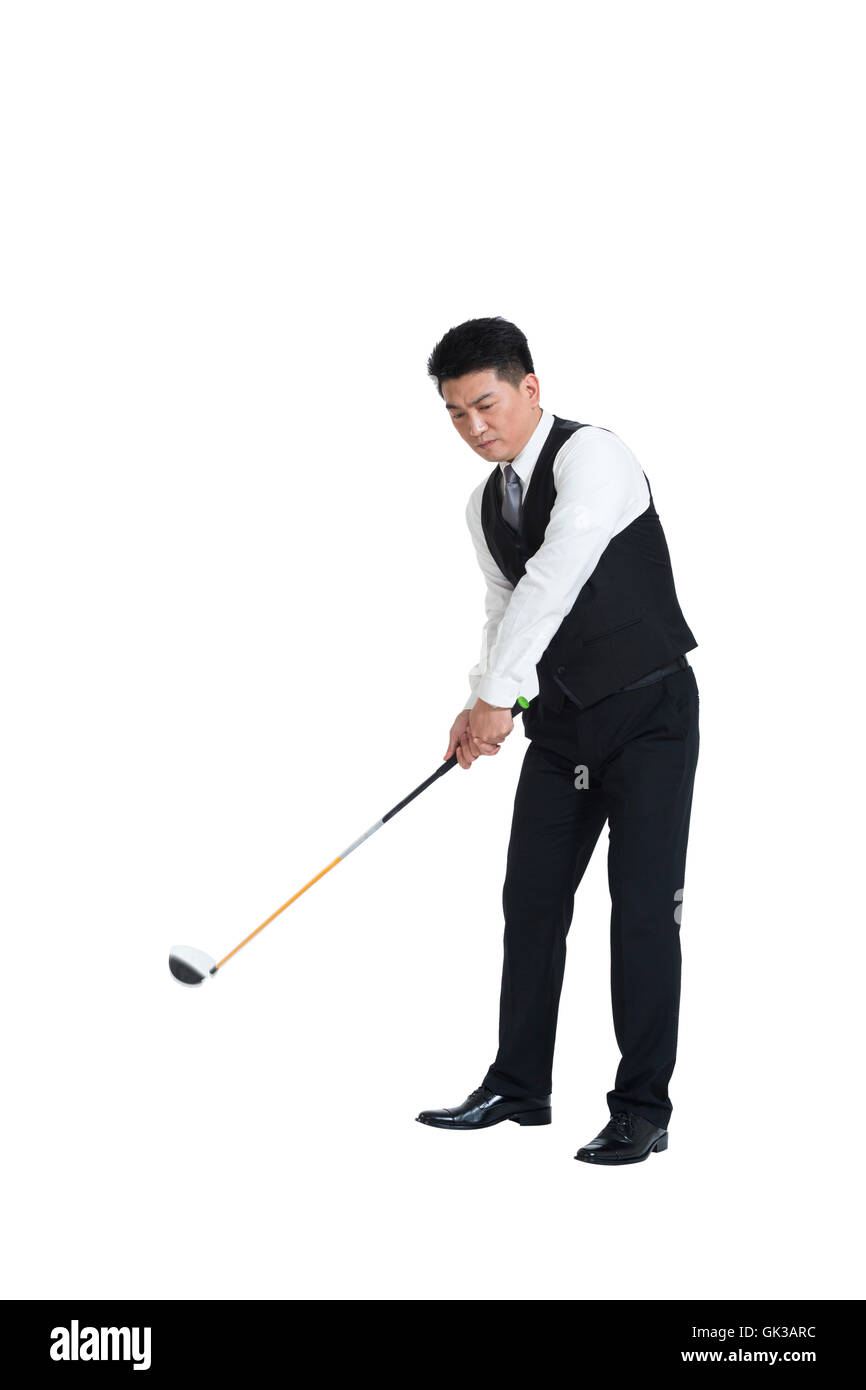 Studio shot business man playing golf Stock Photo - Alamy