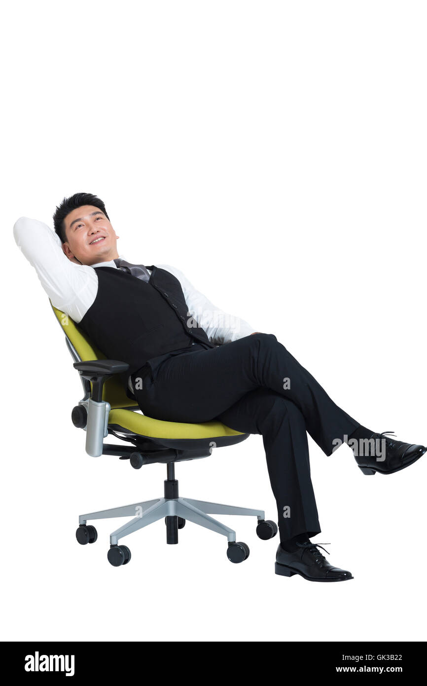 Studio shot business man sitting Stock Photo - Alamy