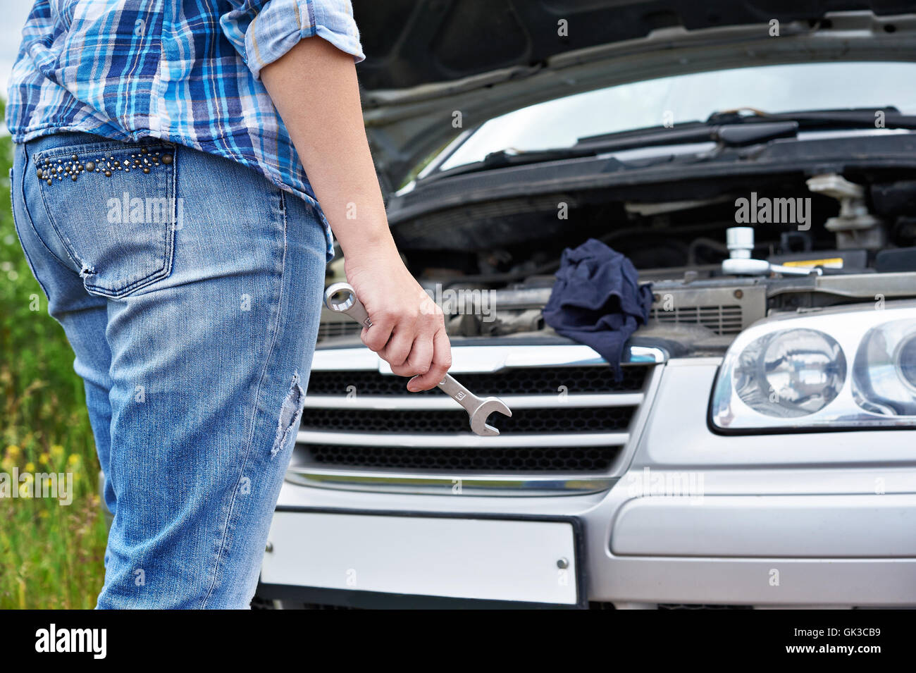 Hand with wrench and repair broken car Stock Photo - Alamy
