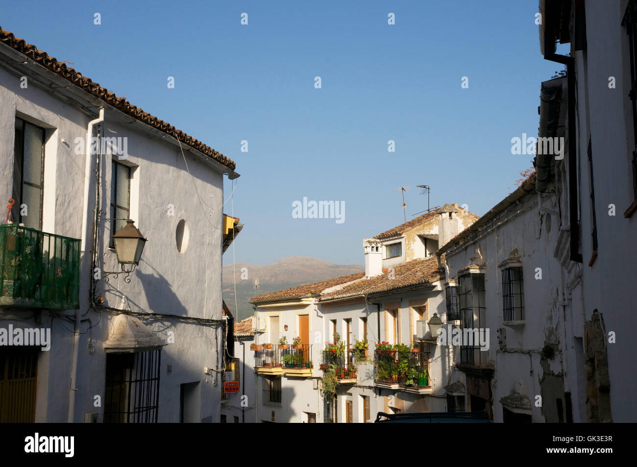 view down street with balconies and flowers Stock Photo - Alamy