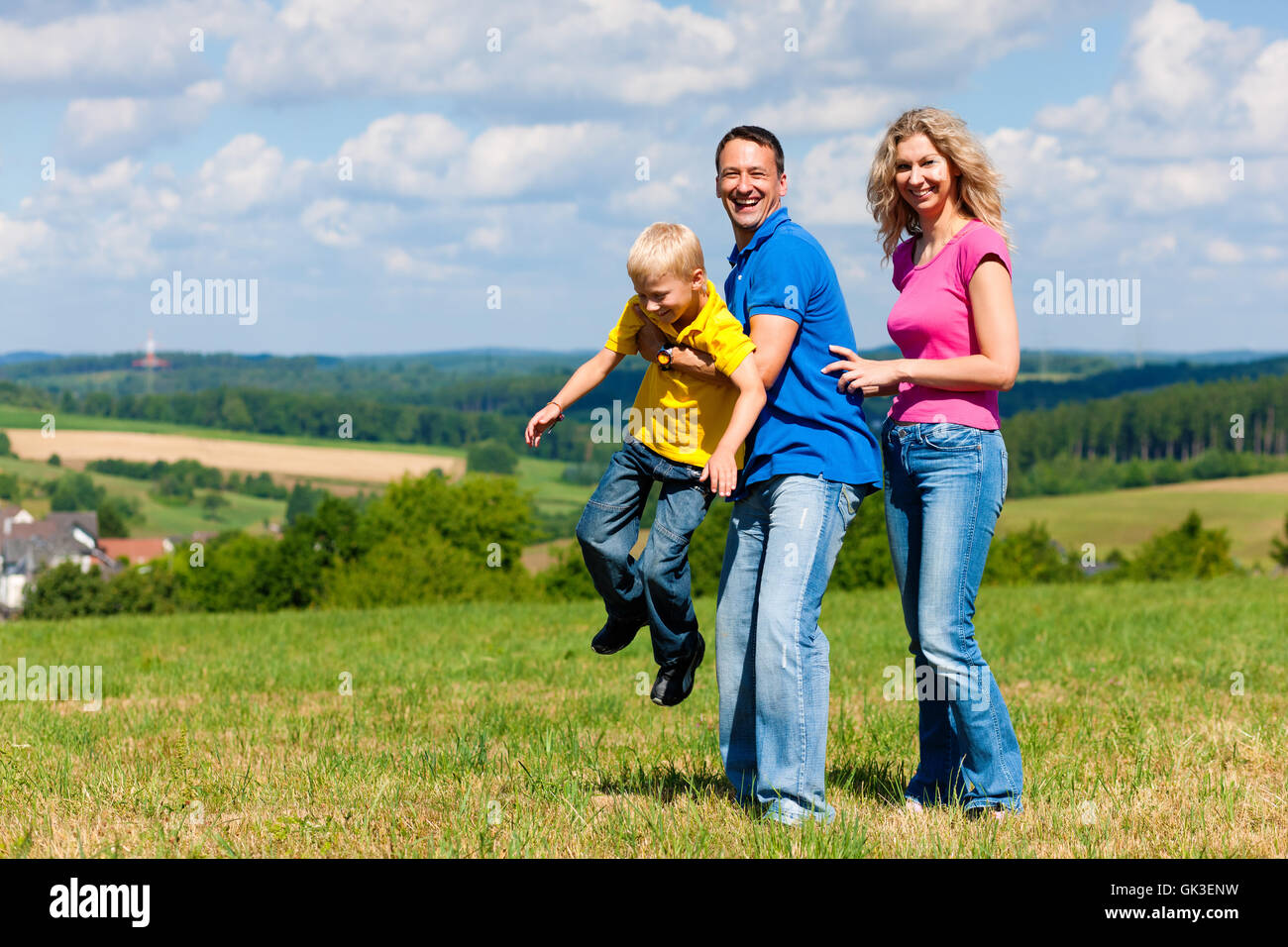 family playing in the meadow Stock Photo - Alamy