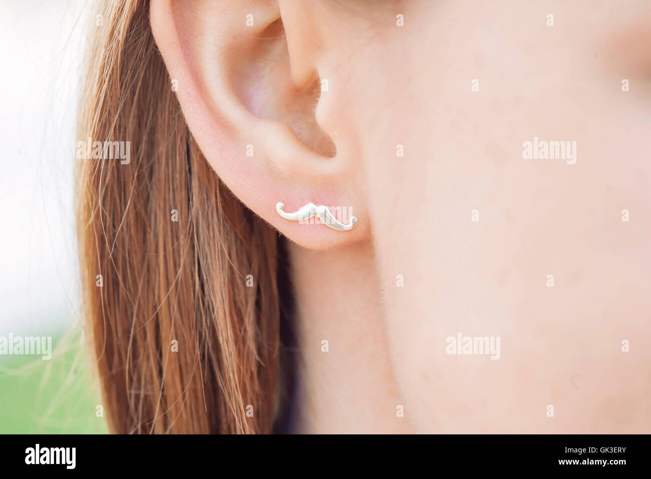 Woman ear wearing beautiful luxury earring Stock Photo - Alamy