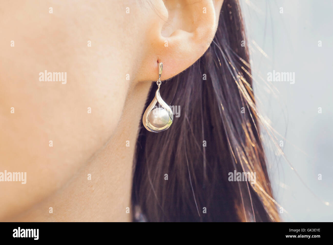 Woman ear wearing beautiful luxury earring Stock Photo - Alamy
