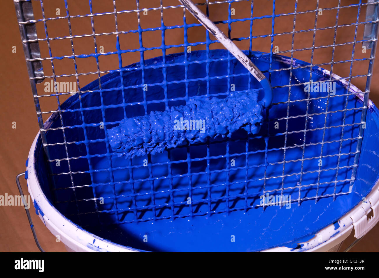 bucket with blue paint and grates Stock Photo - Alamy