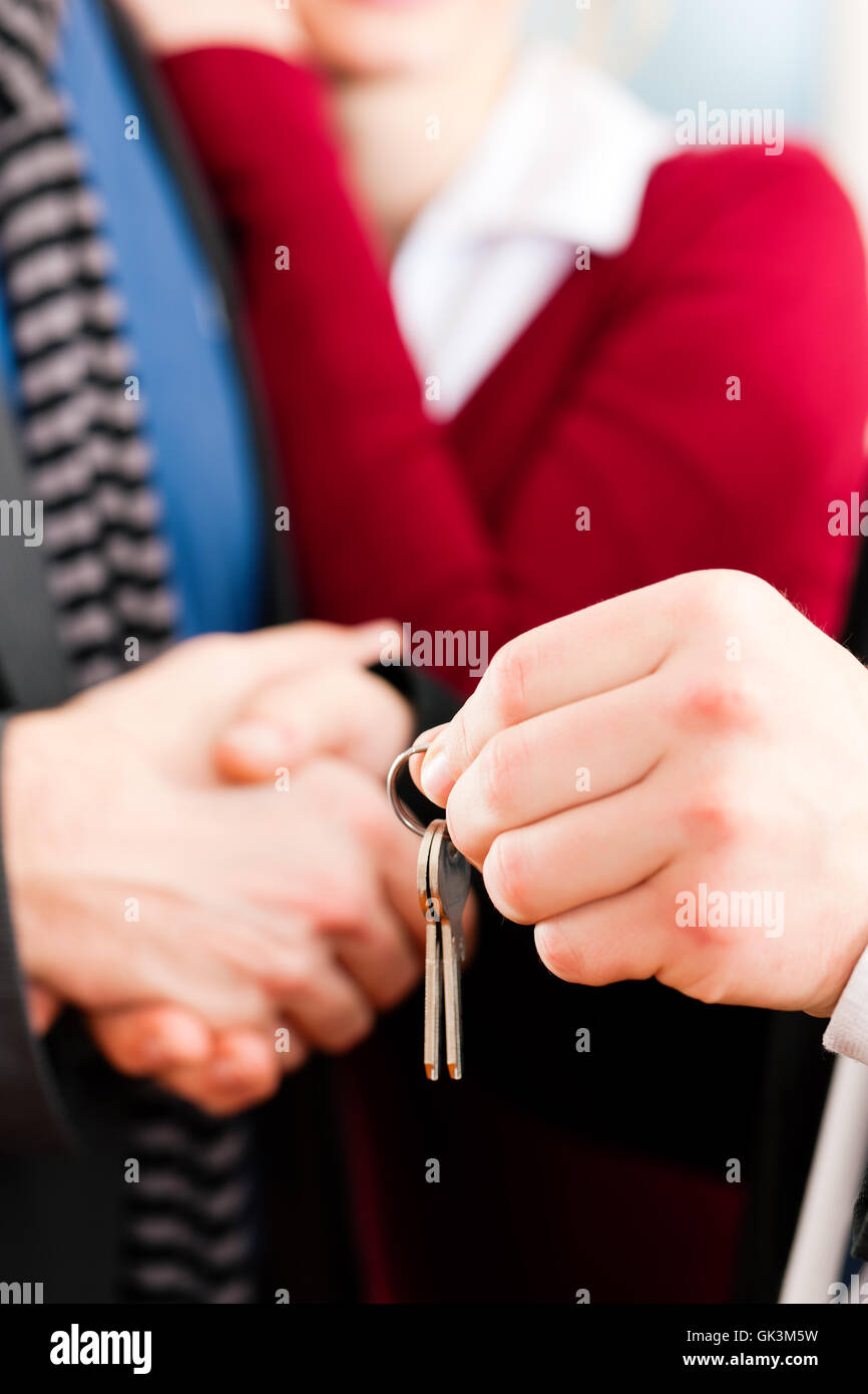 couple receiving keys to the apartment of brokers Stock Photo - Alamy