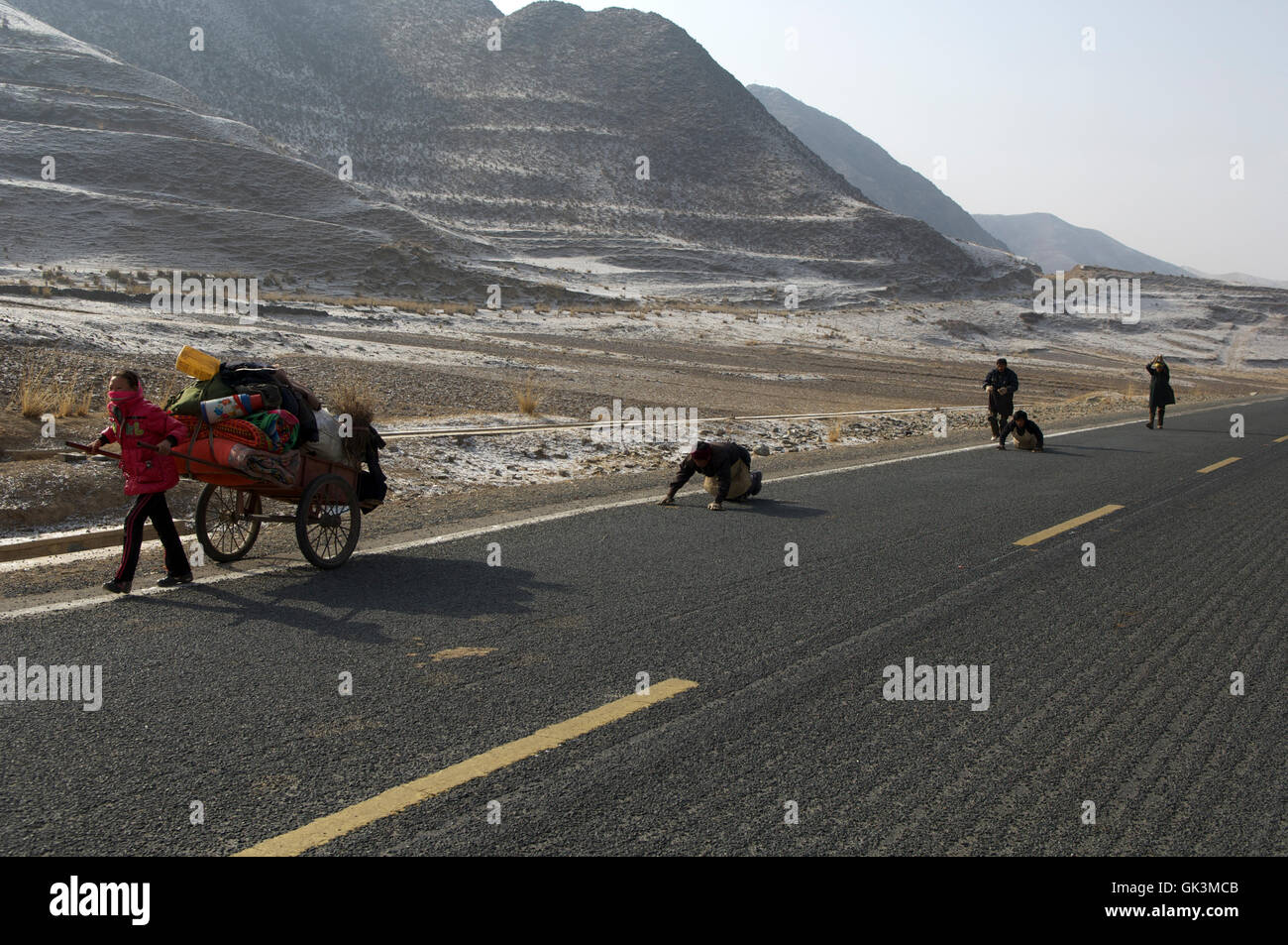 Xiahe, Gansu Province, China --- Pilgrims prostrate themselves towards ...