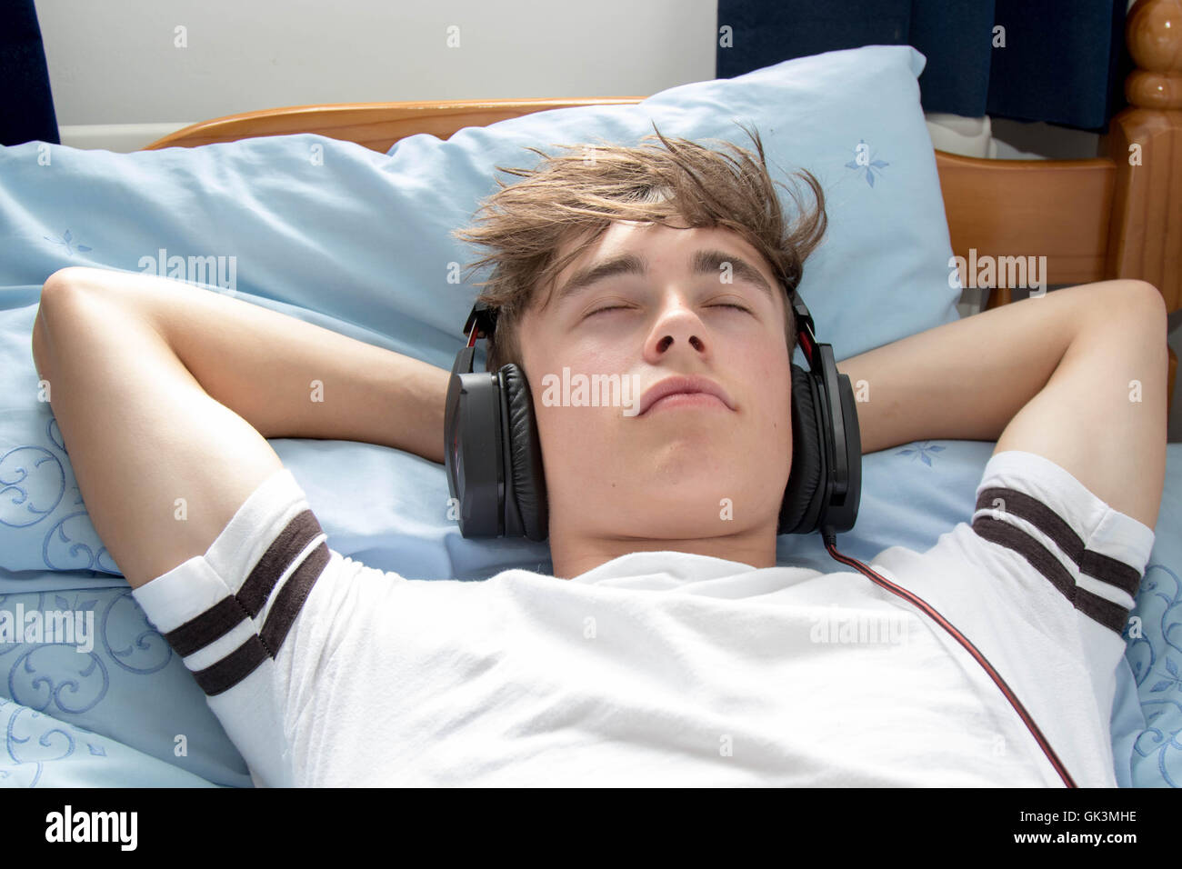 Teenage boy listening to music Stock Photo - Alamy