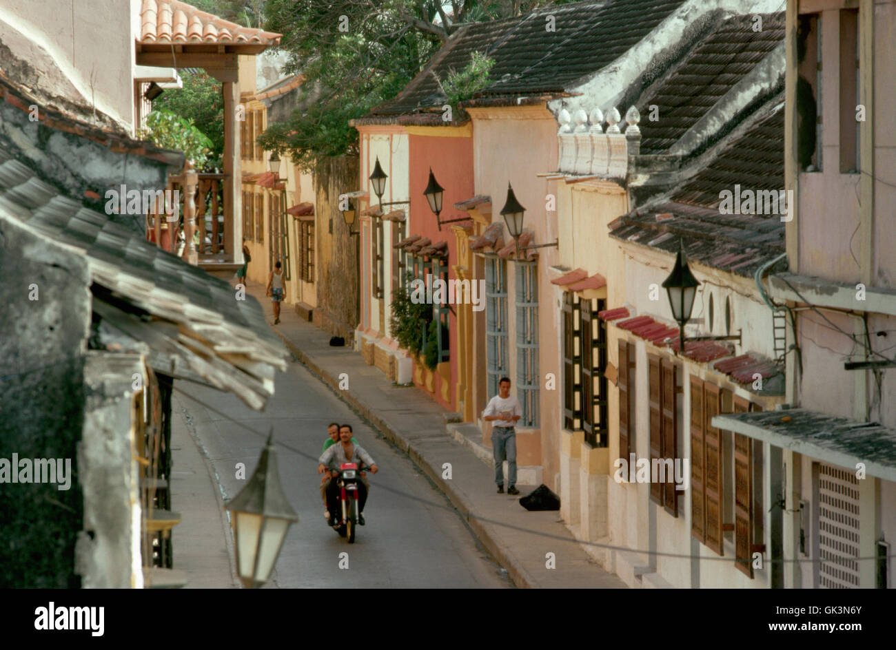 ca. 1980-1995, Cartagena, Colombia --- A motorbike drives past the low ...