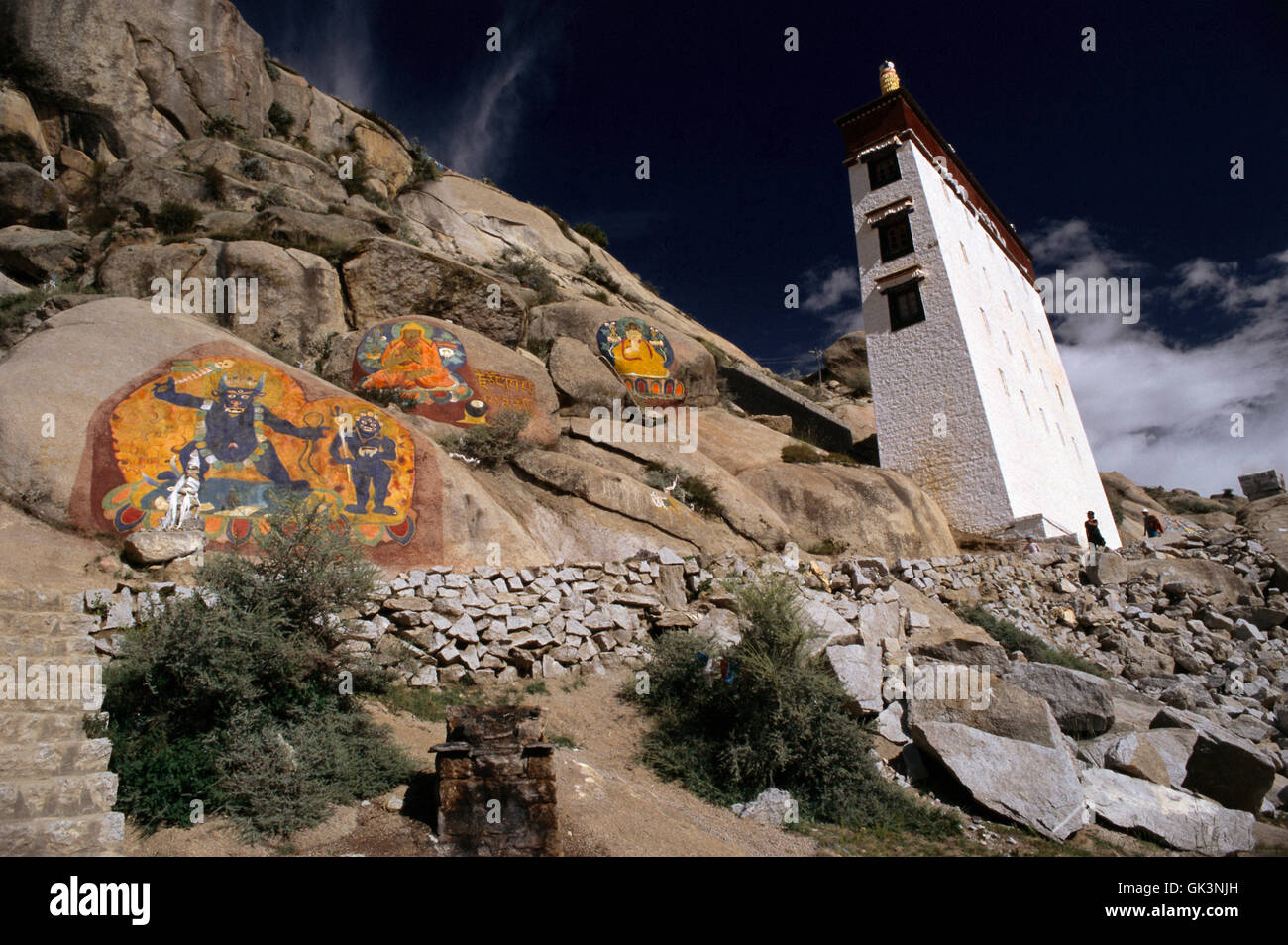 ca. 2003, Lhasa, Tibet, China --- Rock paintings below a tower at the ...