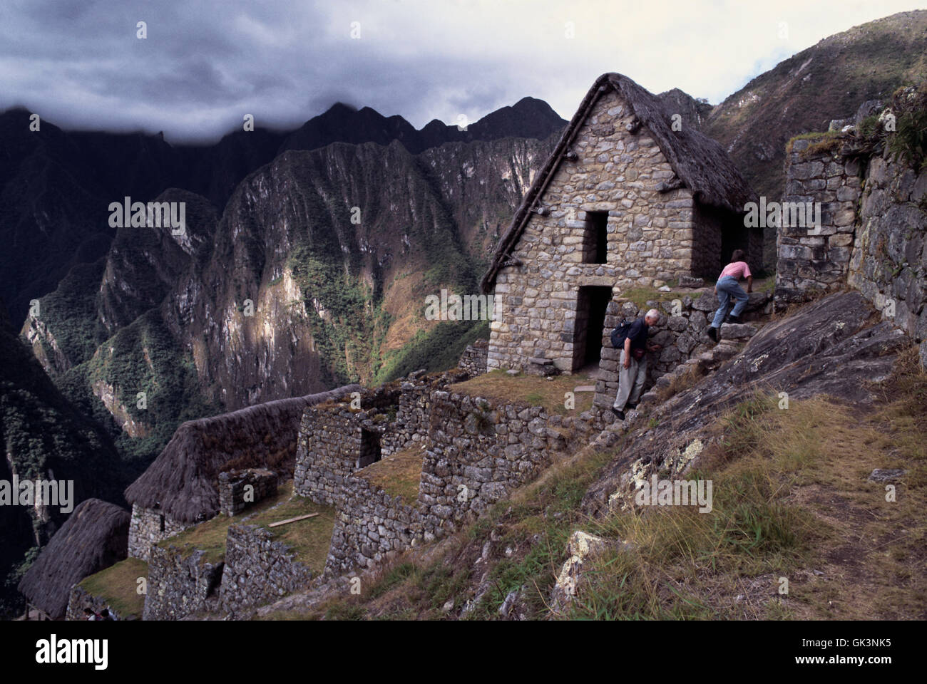 ca. 2003, Machu Picchu, Peru --- Two people explore the Incan ruins of ...