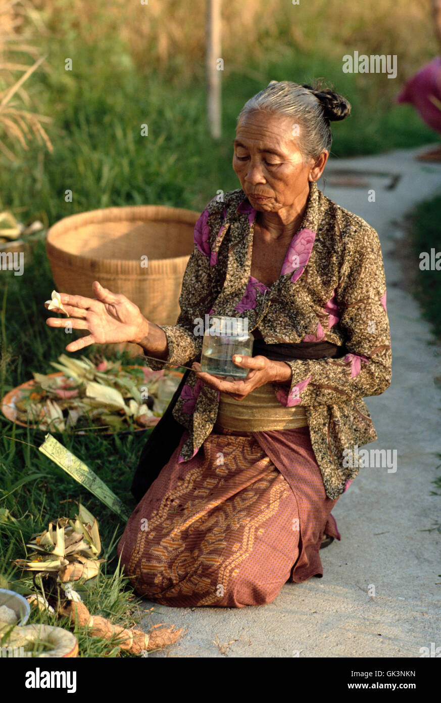 ca. 2003, Bali, Indonesia --- Balinese Woman Praying to Rice Gods ...