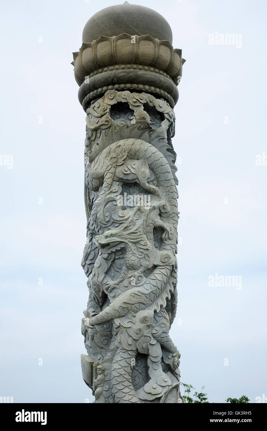 A cement stone dragon pillar at the Guanyin sea goddess buddhist ...