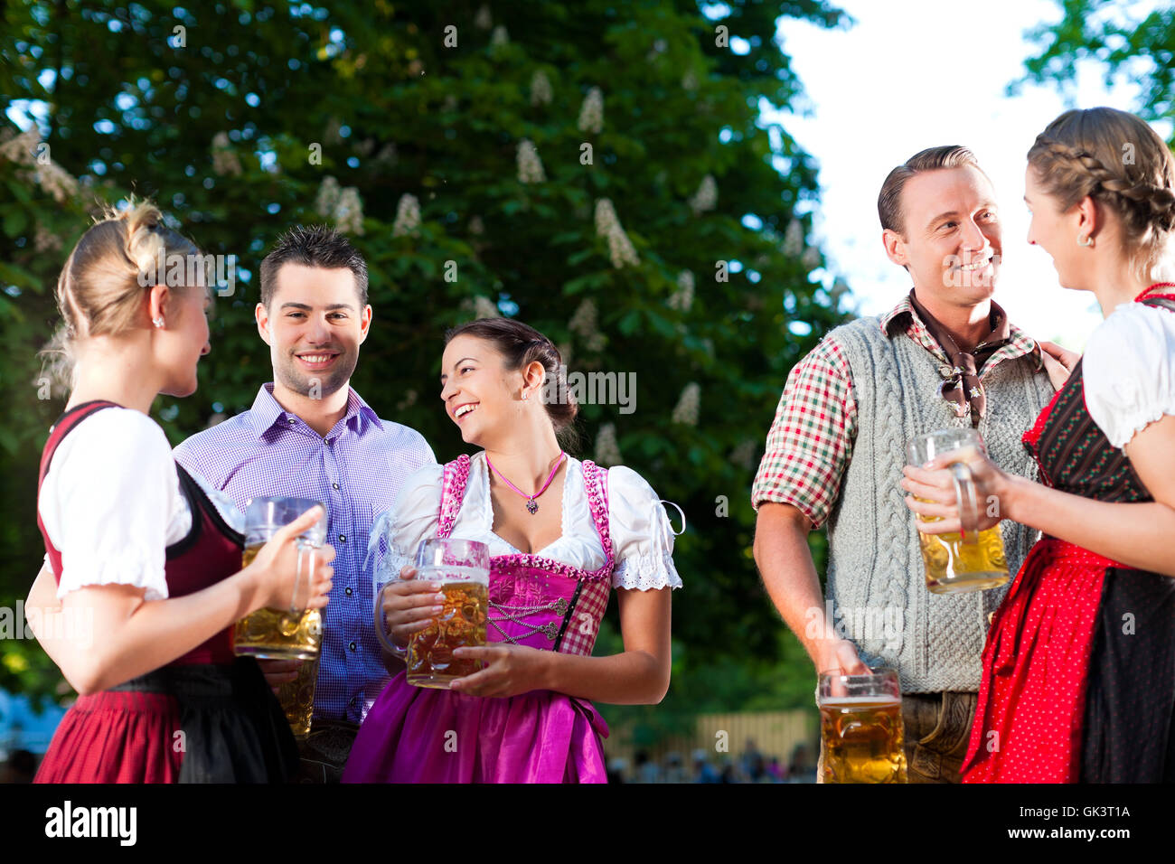 in beer garden - friends drinking beer Stock Photo - Alamy