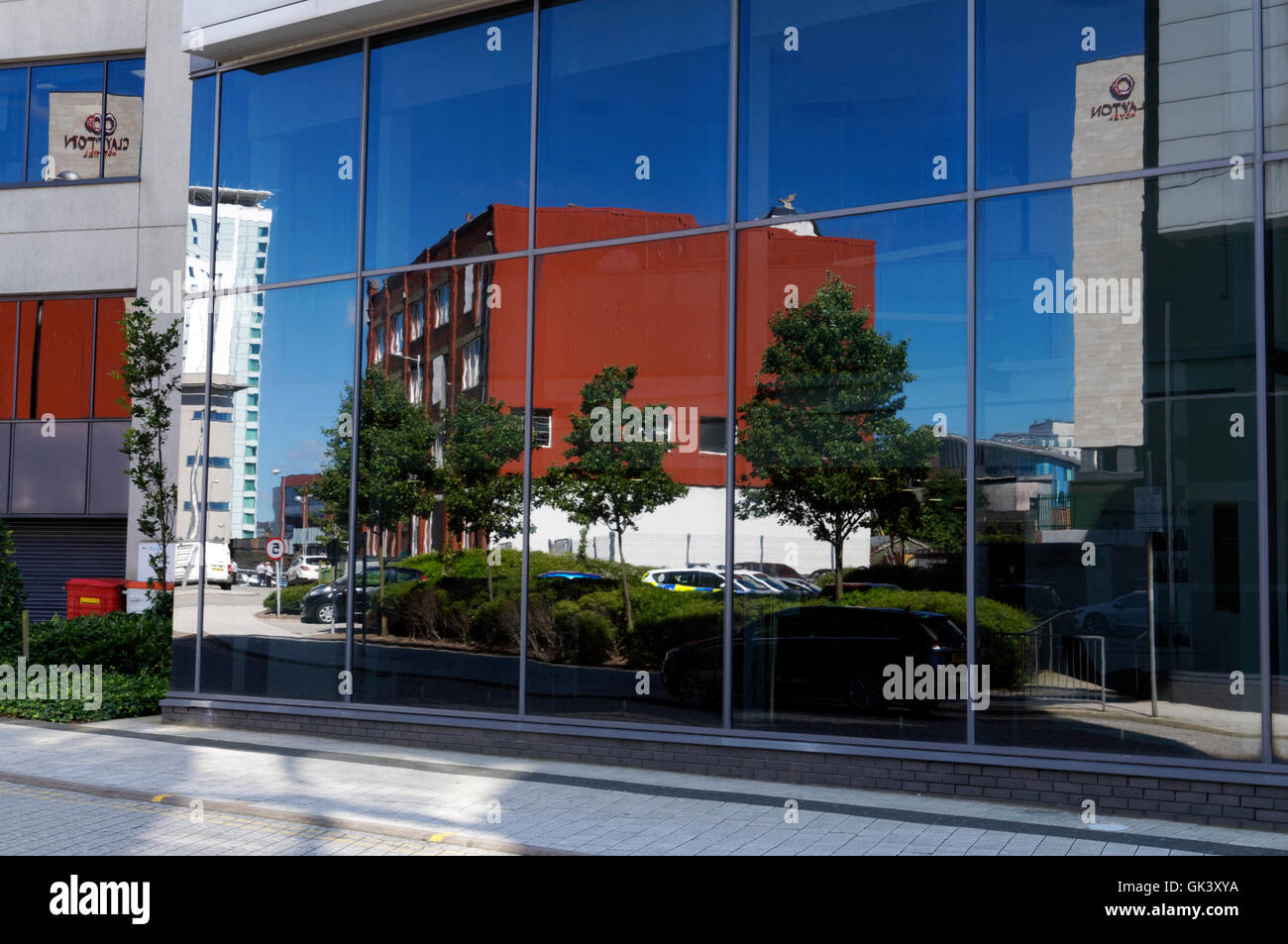Reflection of buildings in large glass window, Callaghan Square ...