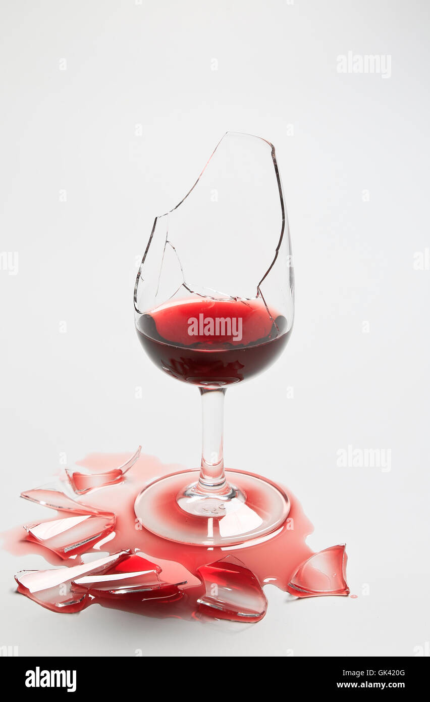Broken Red Wine tasting glass with wine Stock Photo - Alamy